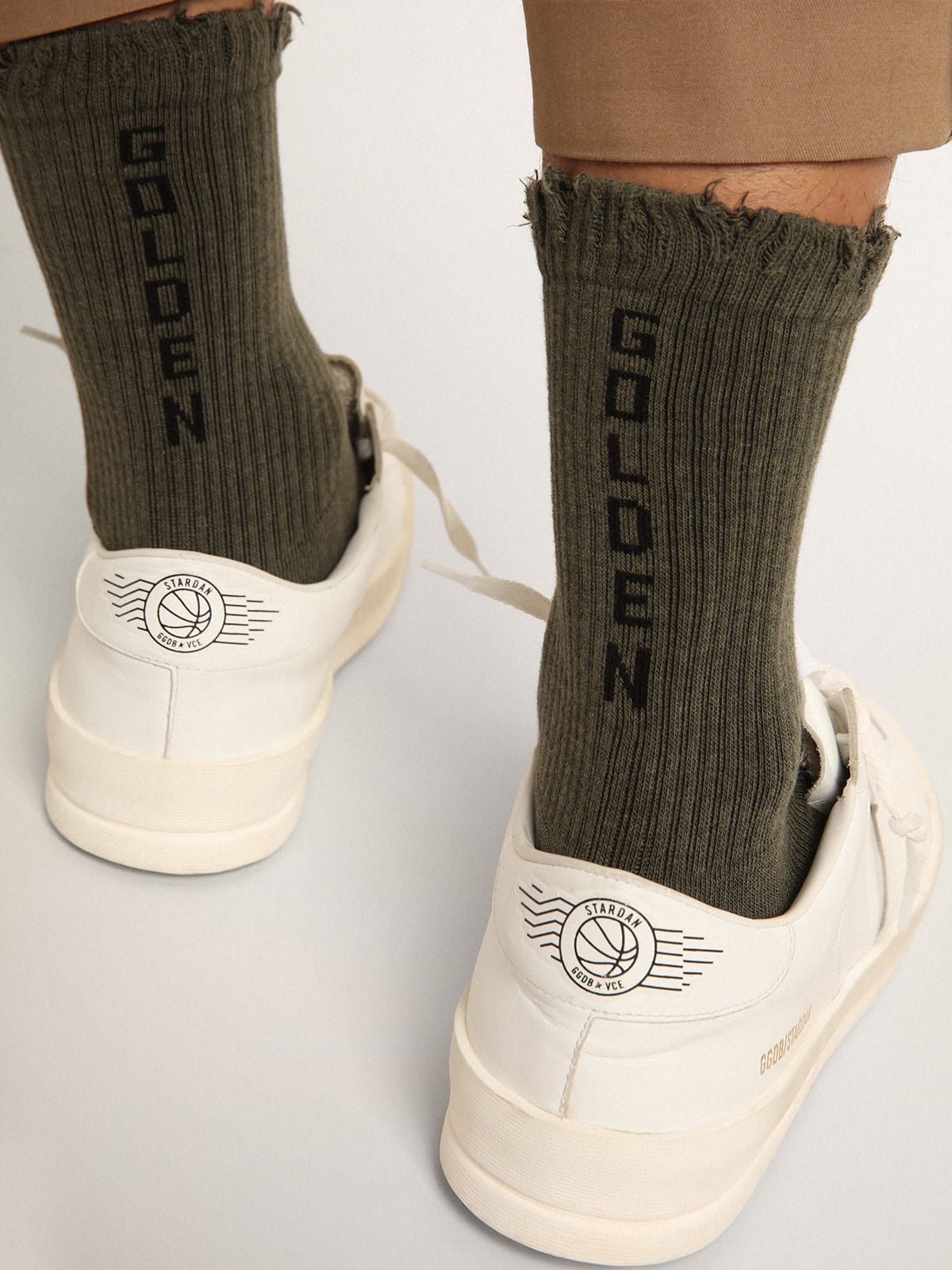 Olive-green cotton socks with distressed finish and black ‘Golden ...